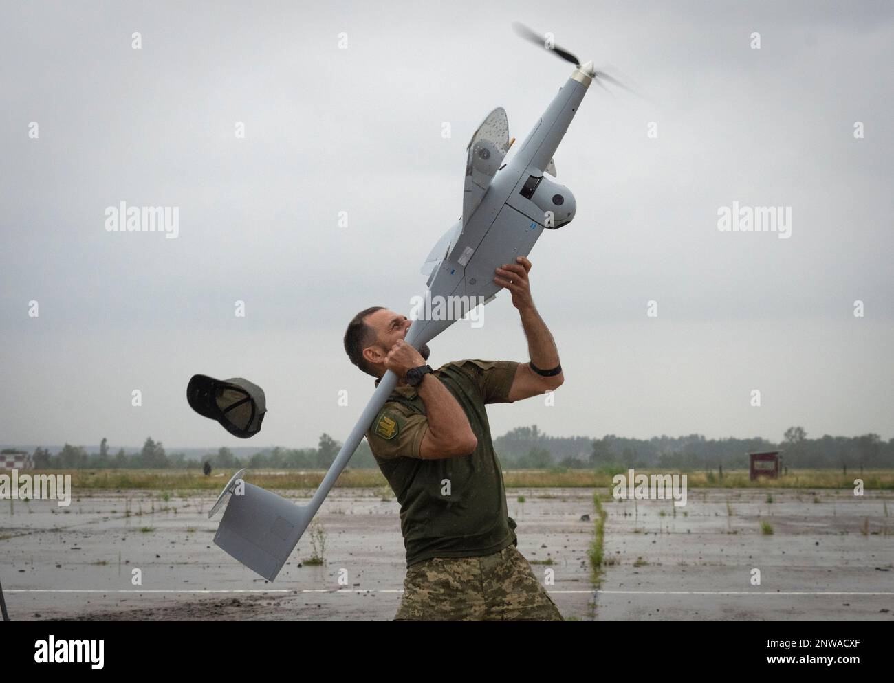 FILE - A Ukrainian soldier launches FlyEye WB Electronics SA, a Polish reconnaissance drone ...