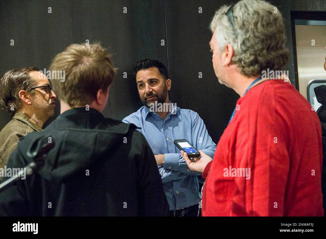 Atlanta Braves General Manager Alex Anthopoulos (center) speaks with ...