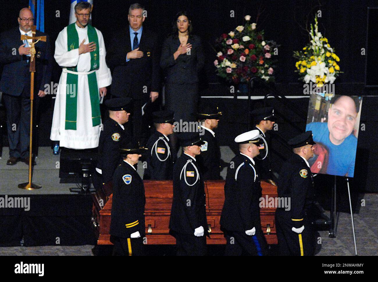 An honor guard carries the casket of paramedic Chris Iverson during a ...