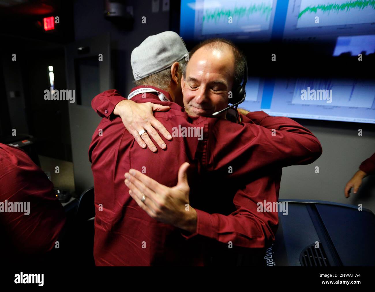 Engineers embrace after the Mars landing of InSight in the mission ...
