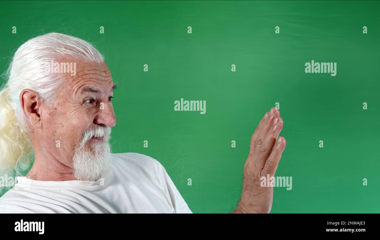 The Old Man Says Hi With His Hand and Smiles Stock Photo - Alamy