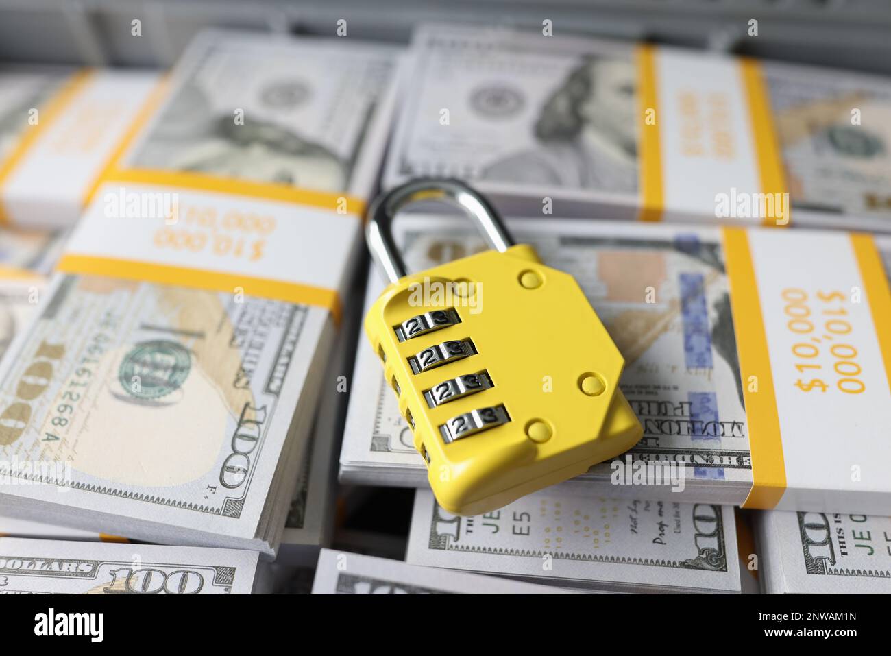 Yellow code lock on top of pile of cash Stock Photo - Alamy