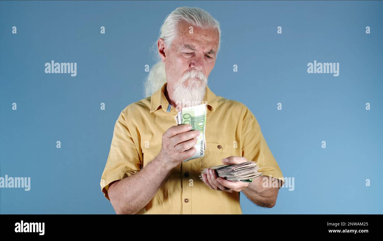 Old man counting saving money hi-res stock photography and images - Alamy