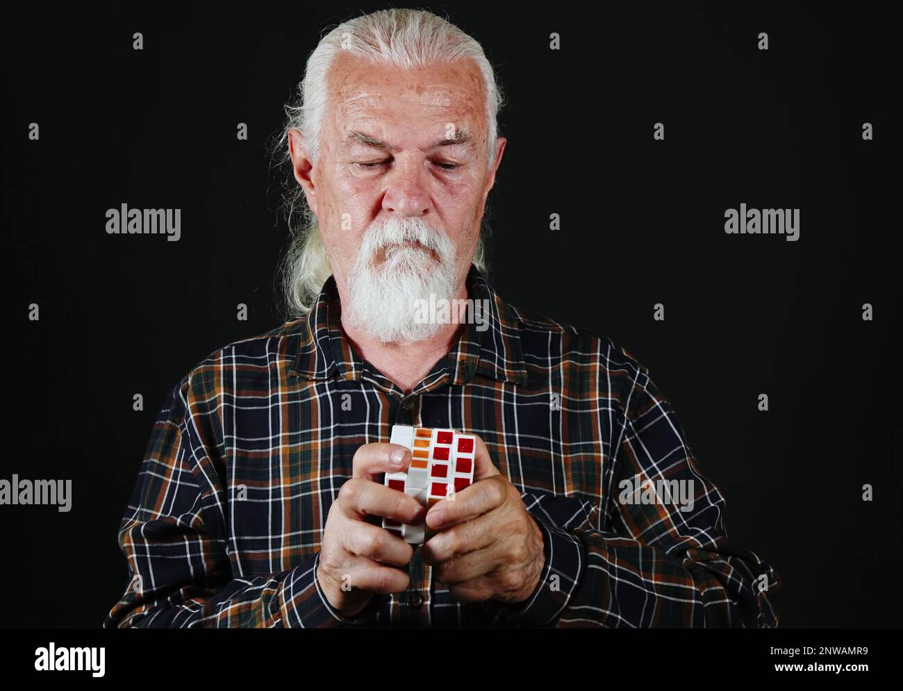 Old Man is Playing with Rubiks Cube Game Photo Stock Photo - Alamy