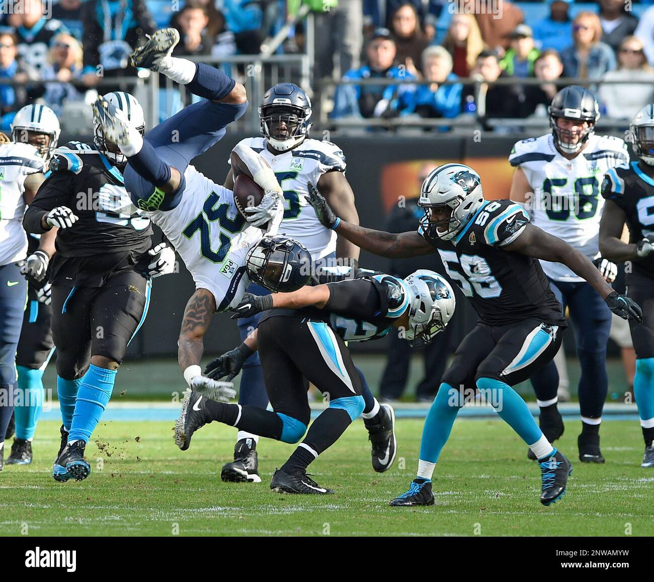 Seattle Seahawks' Chris Carson (32) is upended by Carolina Panthers ...