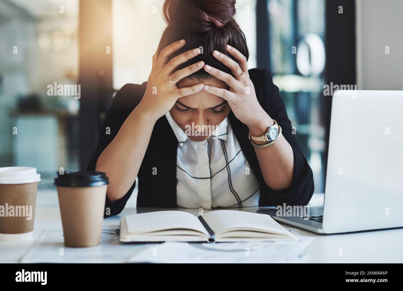 Wheres a vacation when you need one. Shot of a young businesswoman ...