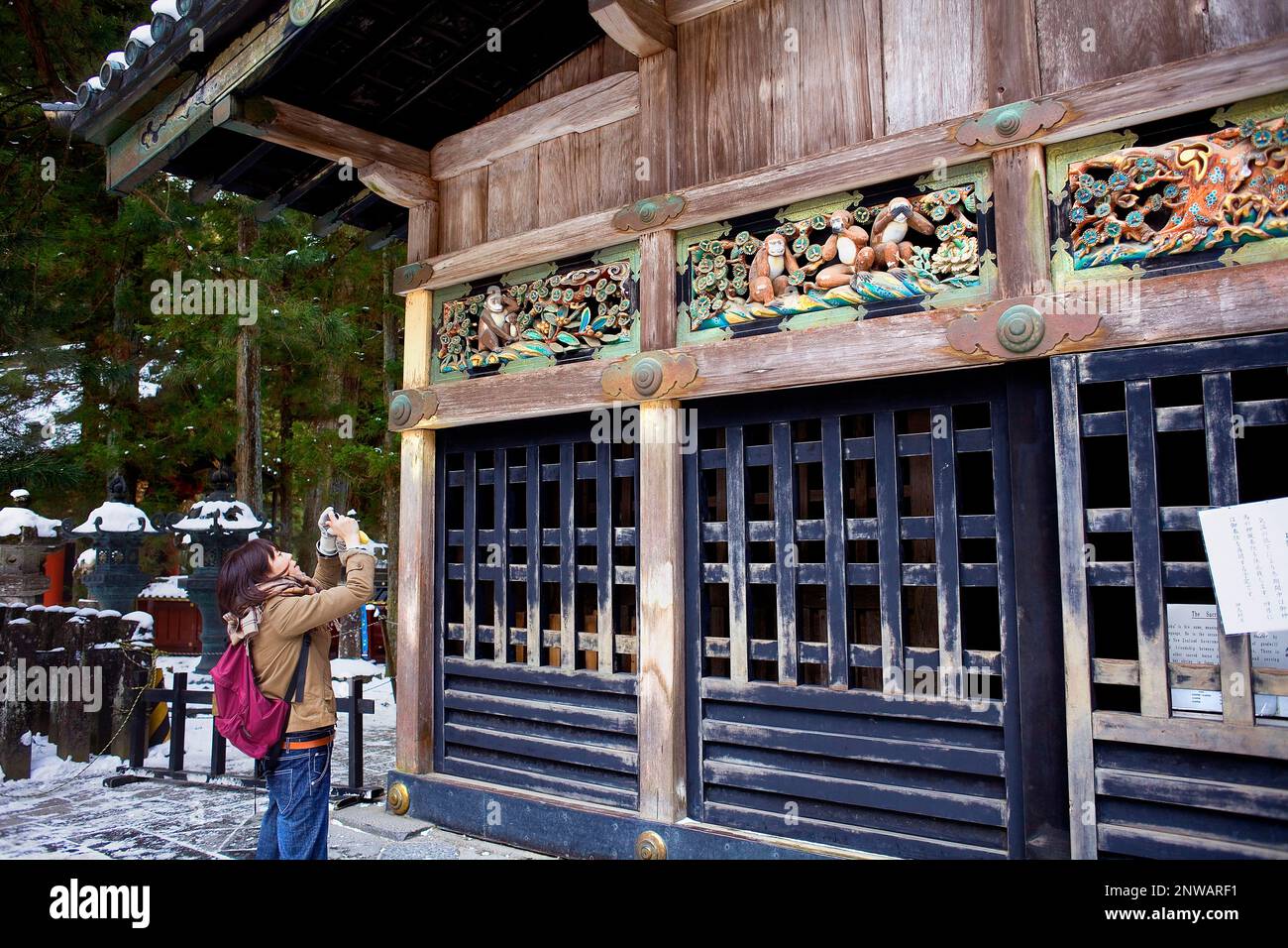 Tourist taking a photograph of Statues of the three wise monkeys ...