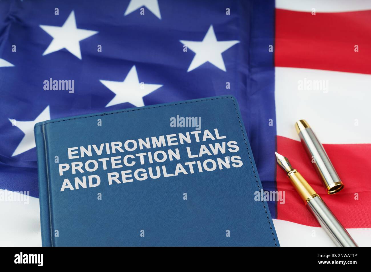 Law concept. On the US flag lies a pen and a book with the inscription ...