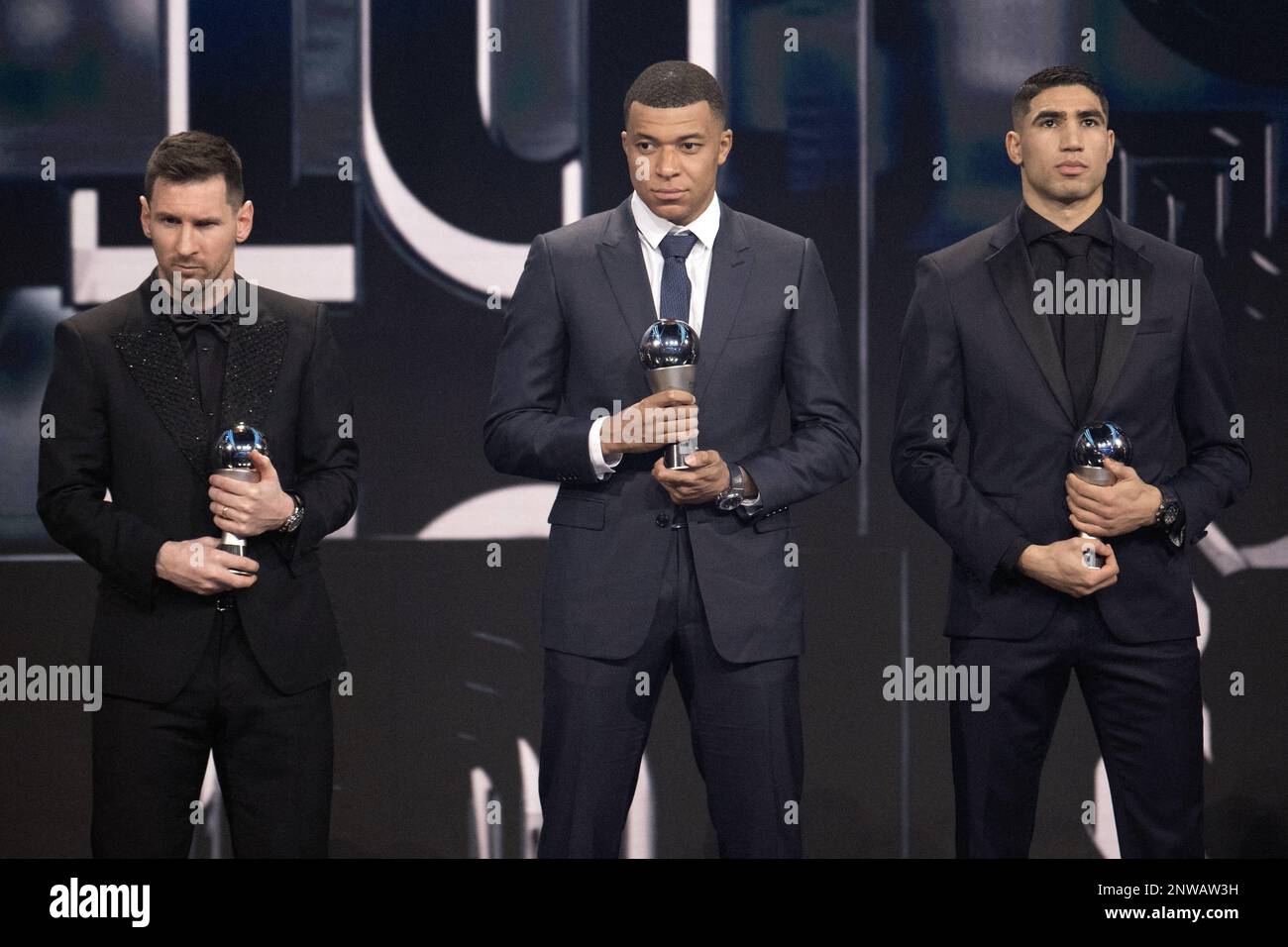 Lionel Messi, Kylian Mbappe and Achraf Hakimi are seen with their trophies after being included ...