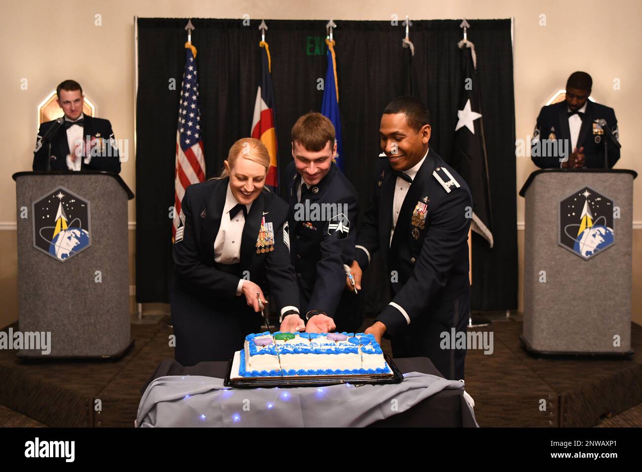 Col. Marcus Jackson, Space Base Delta 2 Commander, cuts the traditional ...