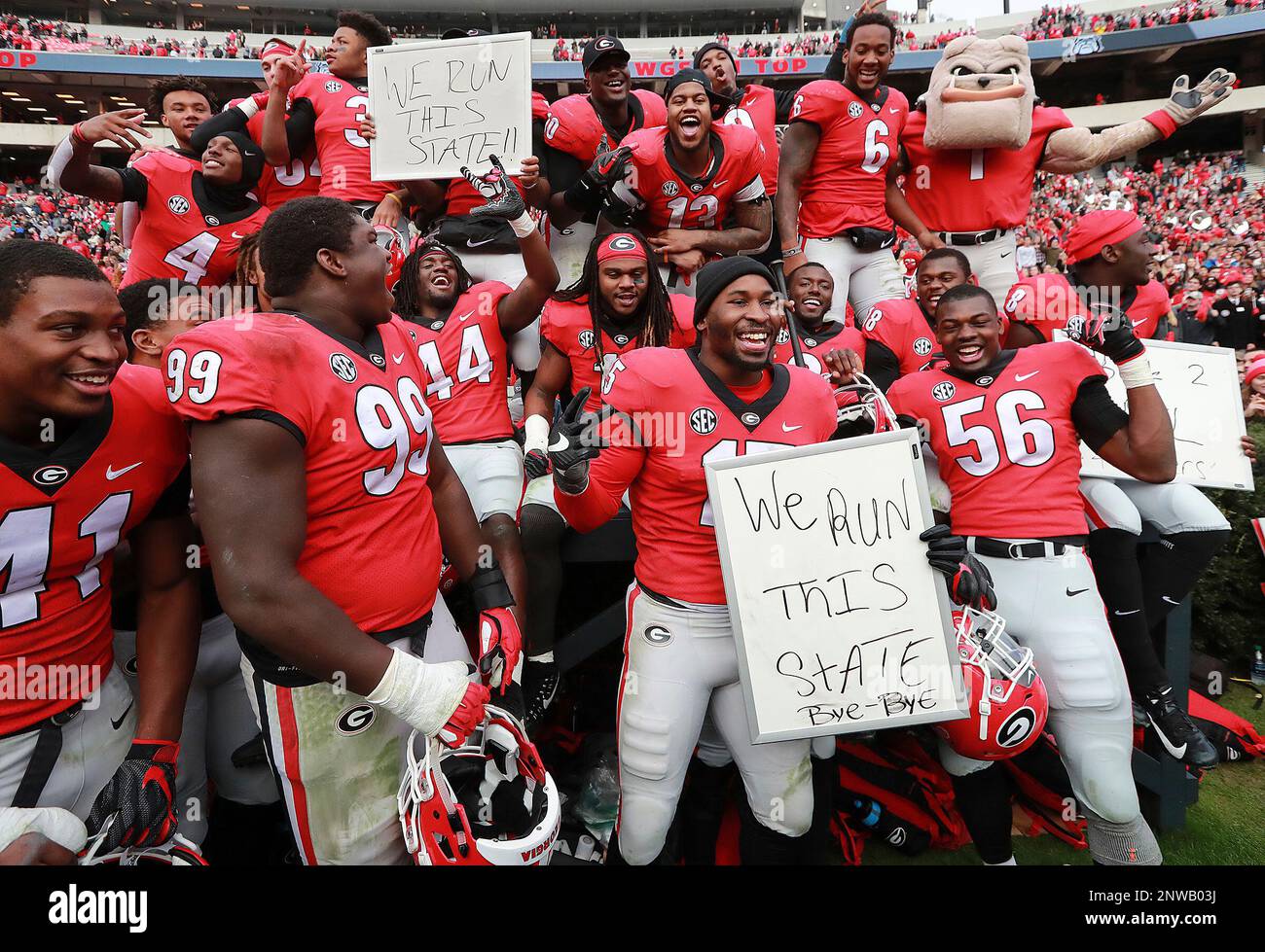 Georgia players holds up a sign as they celebrate after defeating ...