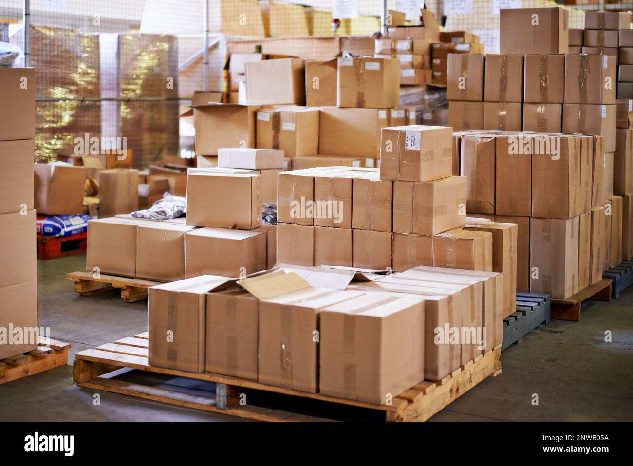Pallets ready to go. Shot of stacked boxes in a large distribution ...