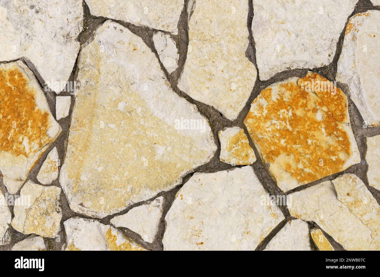 White - yellow texture of a stone wall with shades of different colors ...