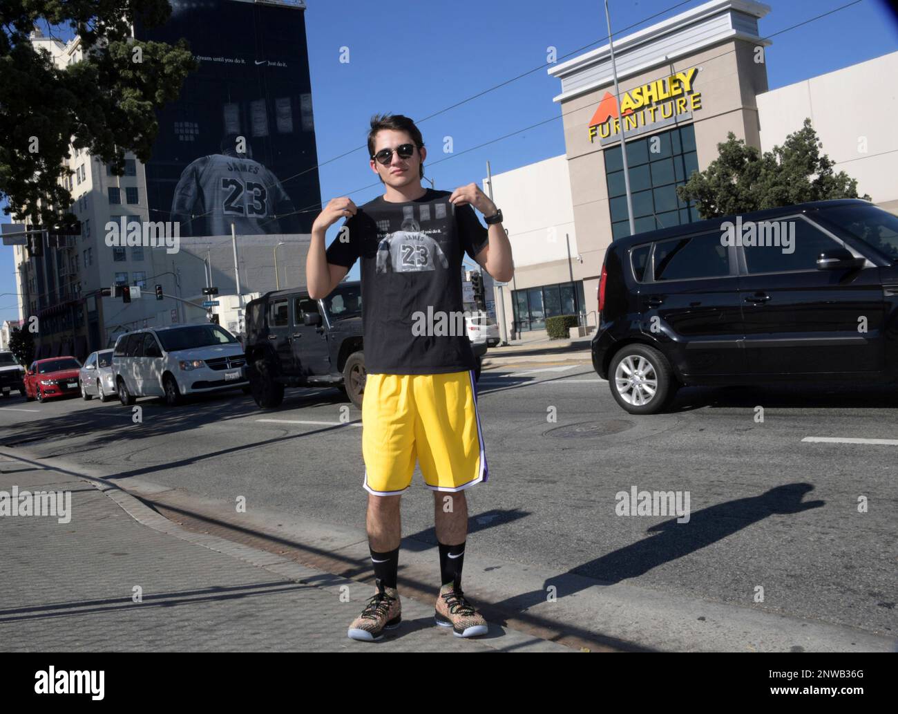 Dylan Stewart of Riverside, Calif. poses in front of Nike ad featuring ...
