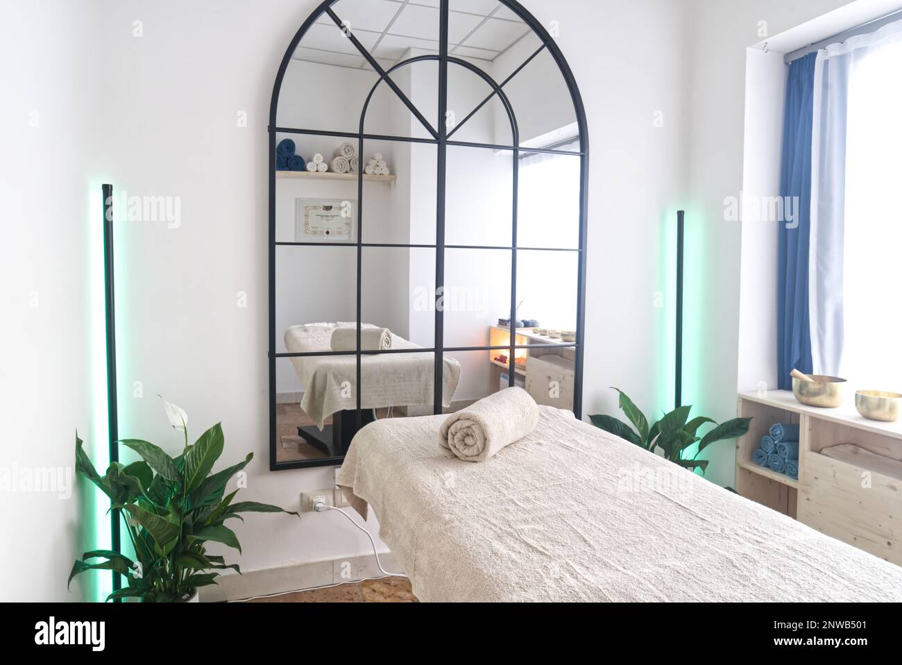 Massage room cosy interior with a big mirror in front of the massage ...