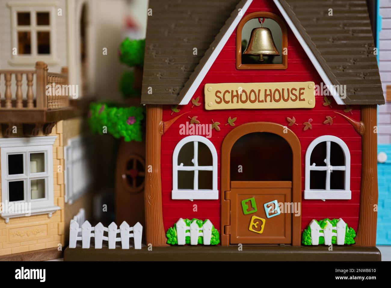 Red school house with bell plastic toy Stock Photo - Alamy