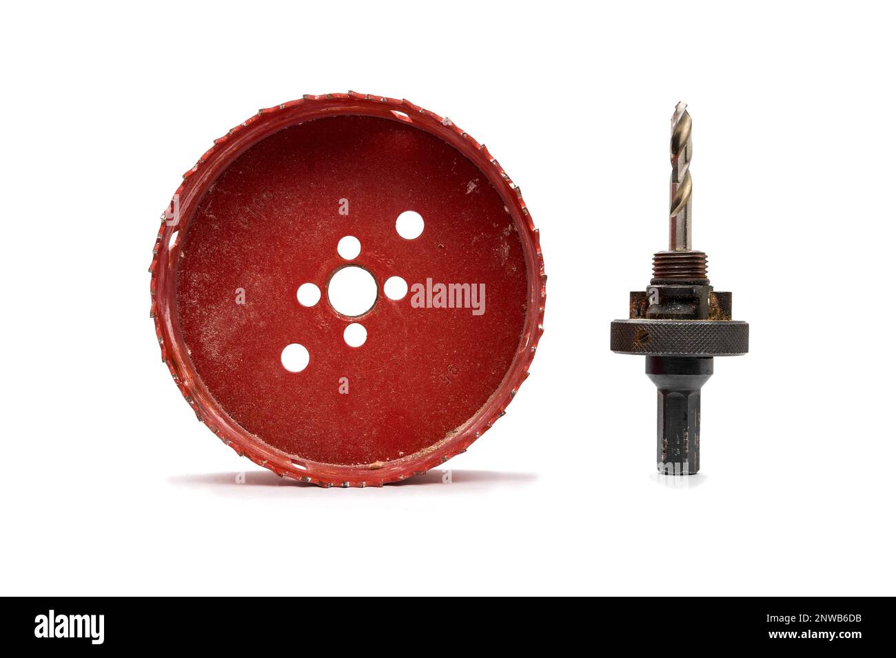 Red used hole saw and holder with drill bit, isolated on white ...