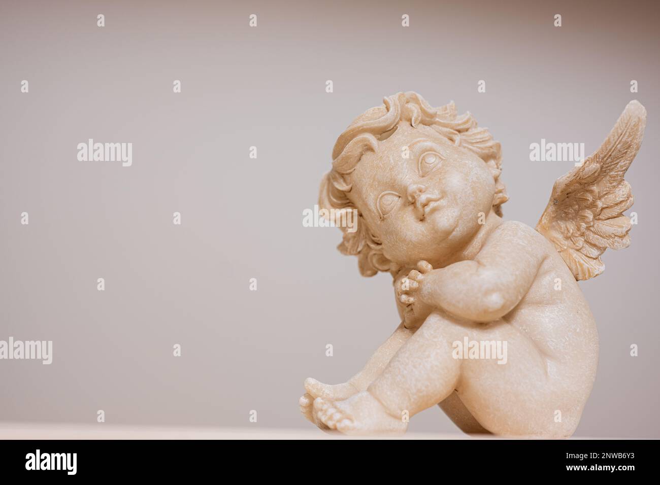 Baby angel with wings antique statue isolated Stock Photo - Alamy