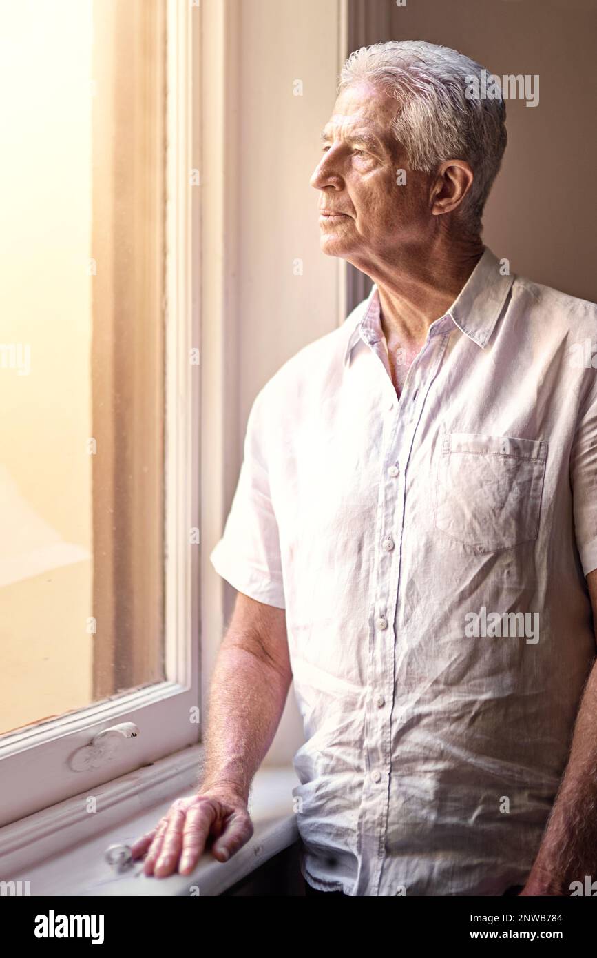 Love leaves a memory no one can steal. Shot of a senior man looking ...