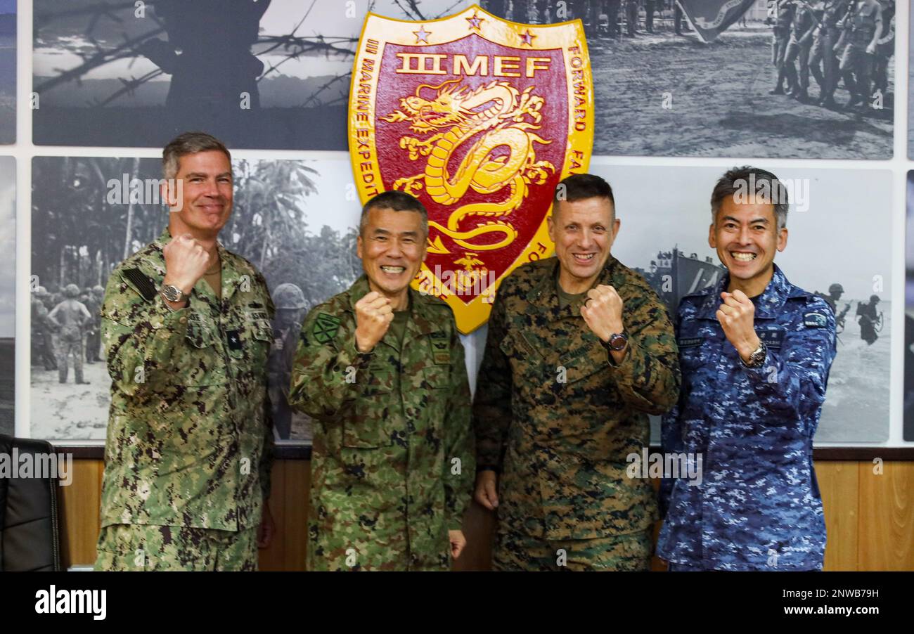 U.S. Navy Rear Adm. Derek Trinque, commander Task Force 76/3, left ...
