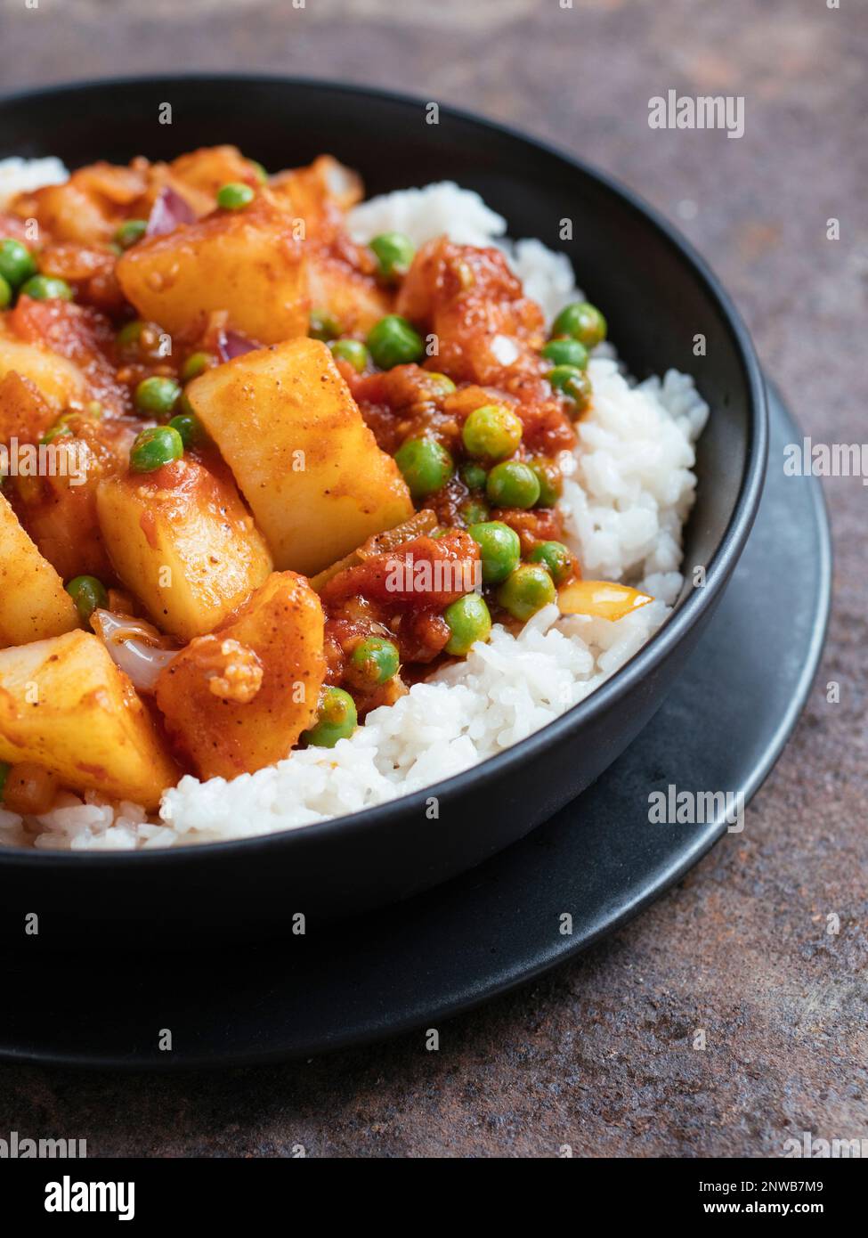 Potato and Pea Curry on Rice Stock Photo - Alamy
