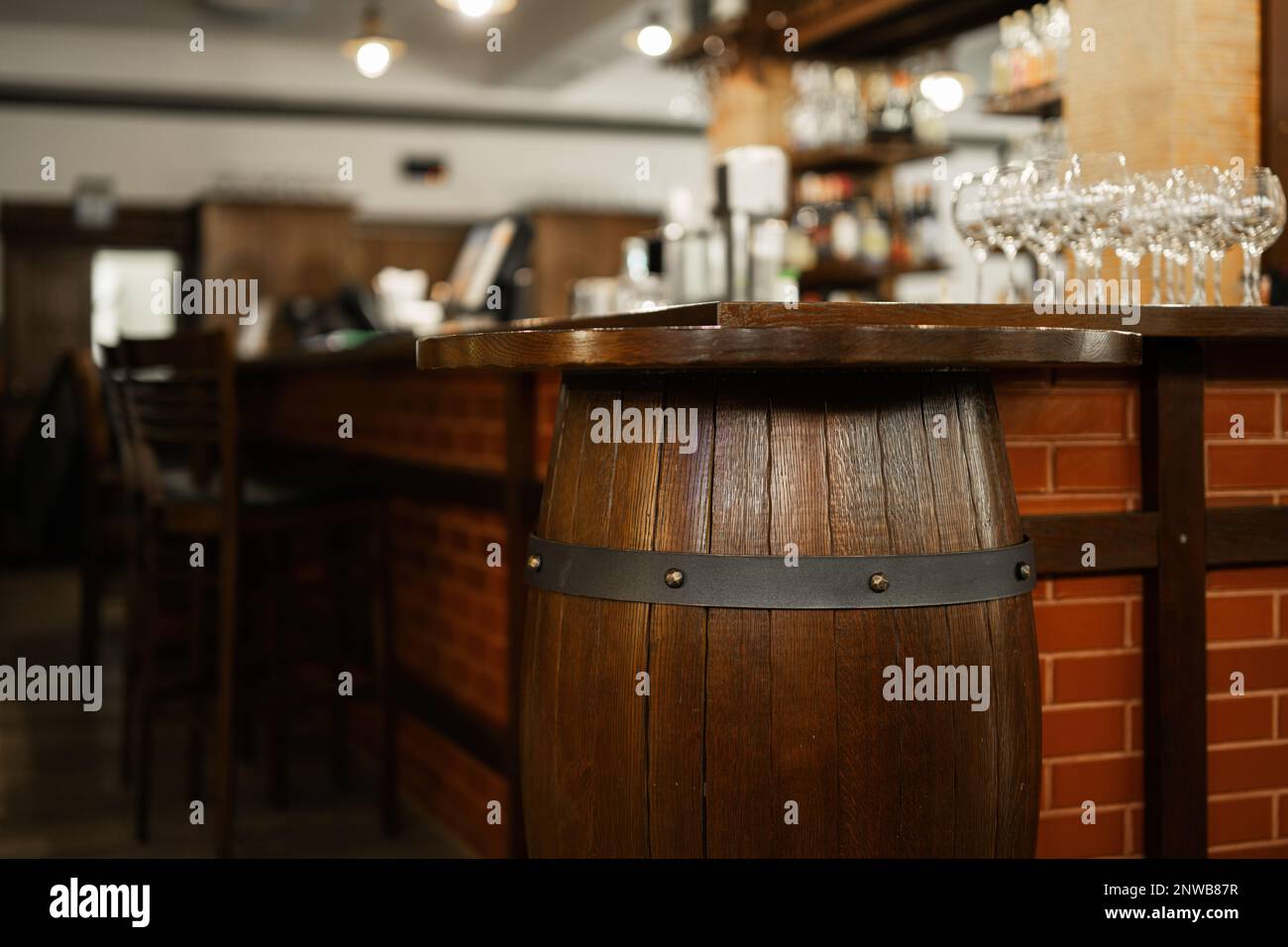 Empty bar with old barrel interior, wooden furniture and pub counter ...