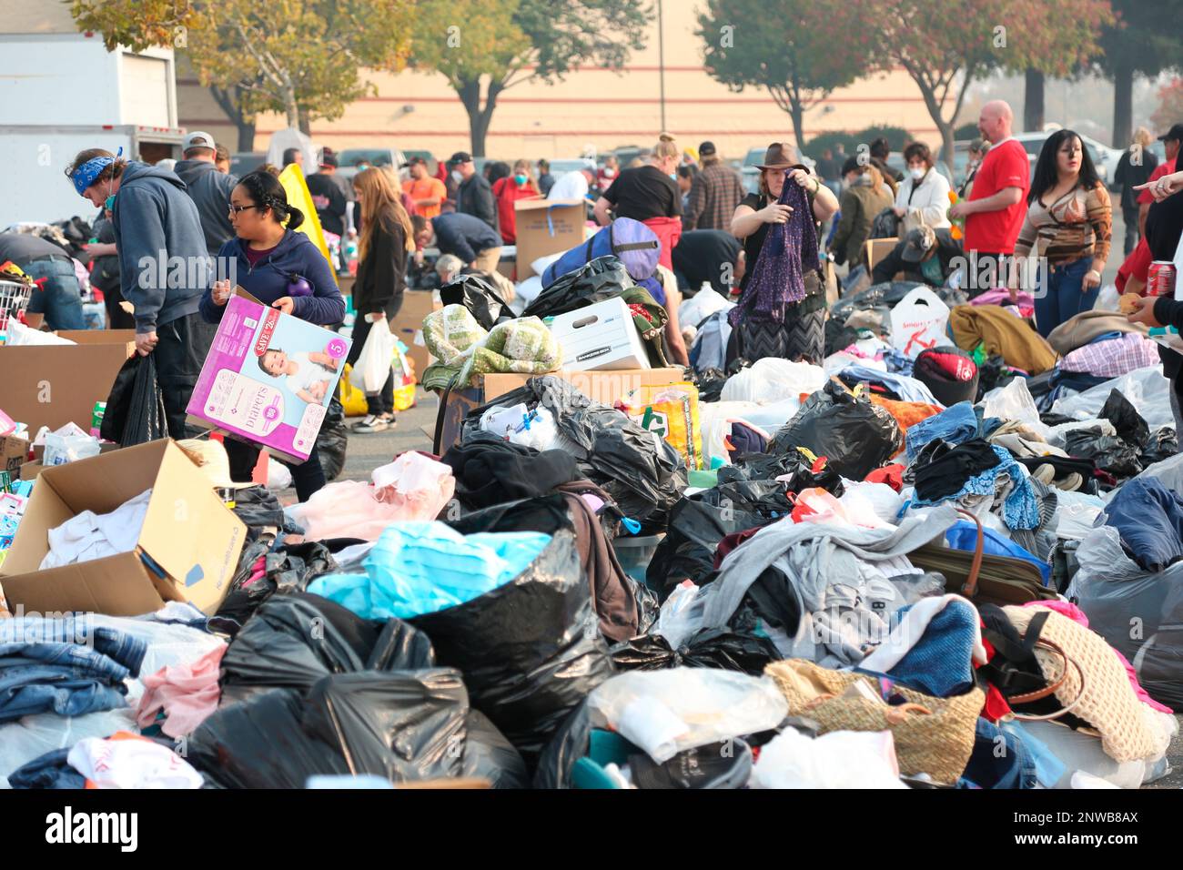 Piles of donated items fill up a section of parking lot surrounding the ...
