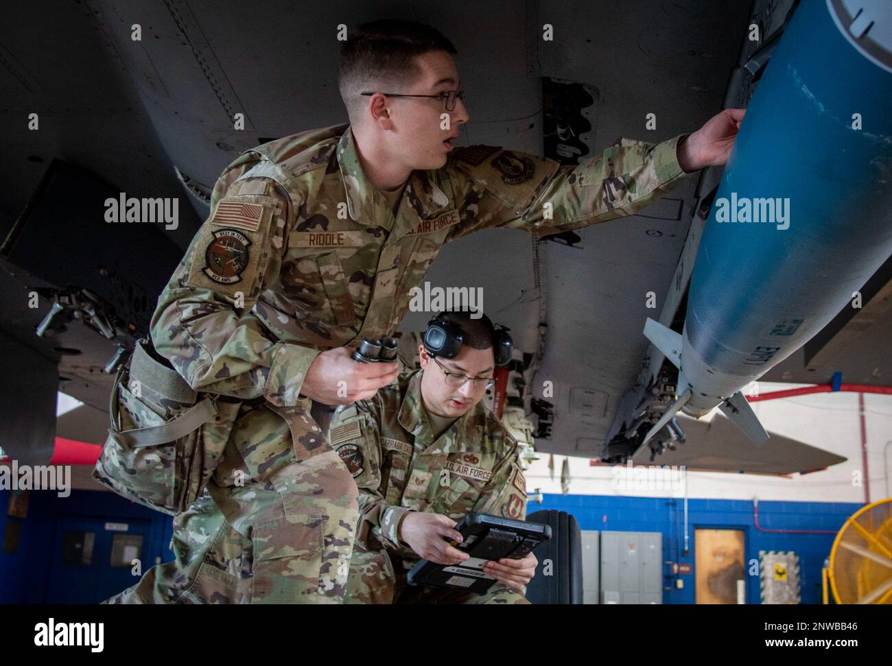 Airman 1st Class Austin Riddle finishes securing a GBU-38 on an F-15 as ...