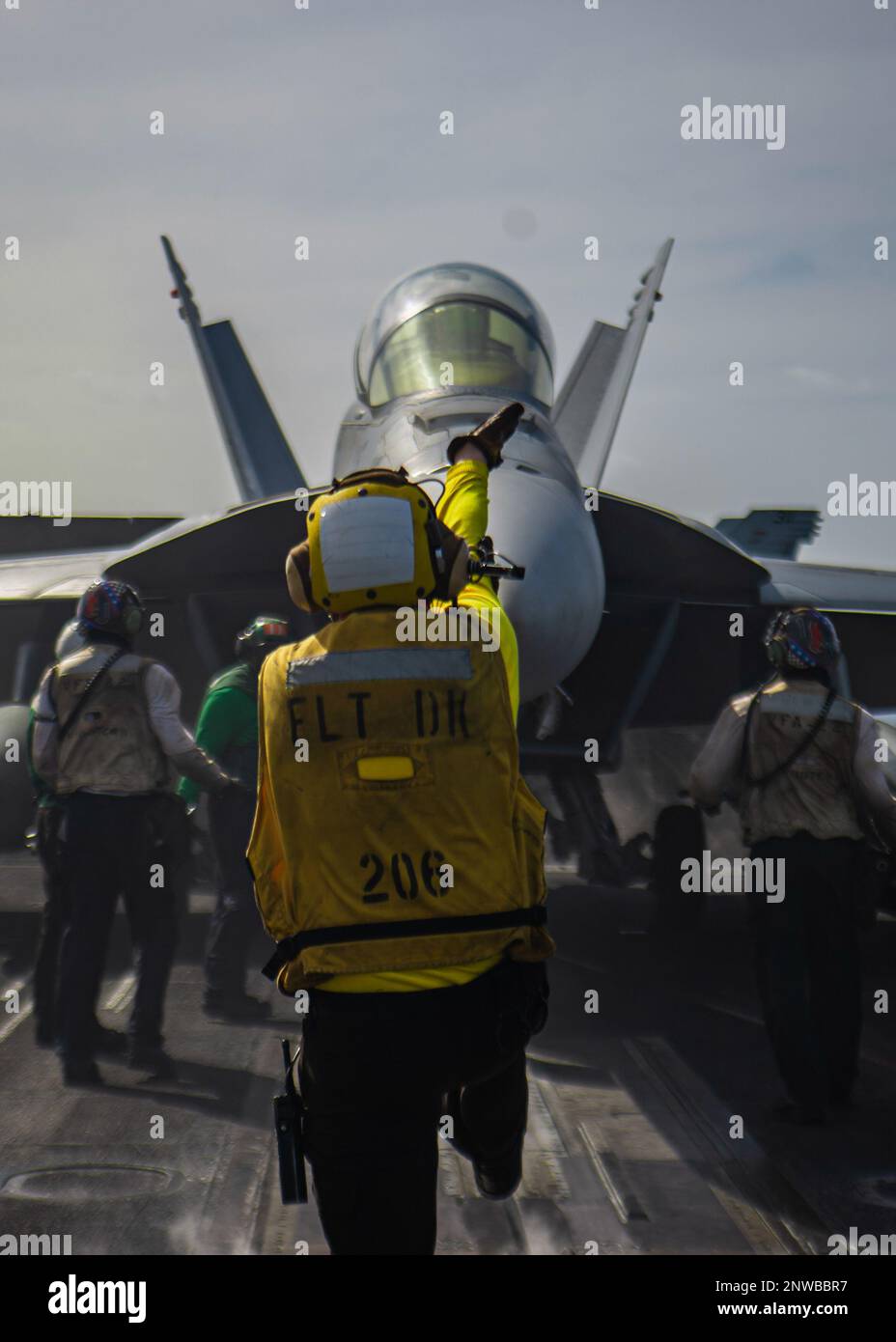 230110-N-MH015-1083 PHILIPPINE SEA (Jan. 10, 2023) A U.S. Navy Sailor directs an F/A-18E Super ...