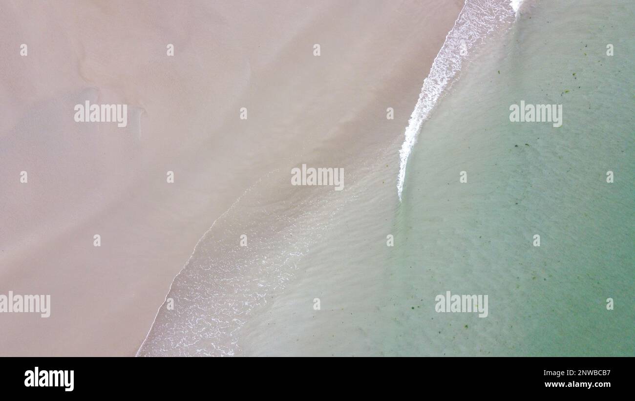 Sandy seashore, top view. Minimalistic seascape, a copy space. Wet sand ...
