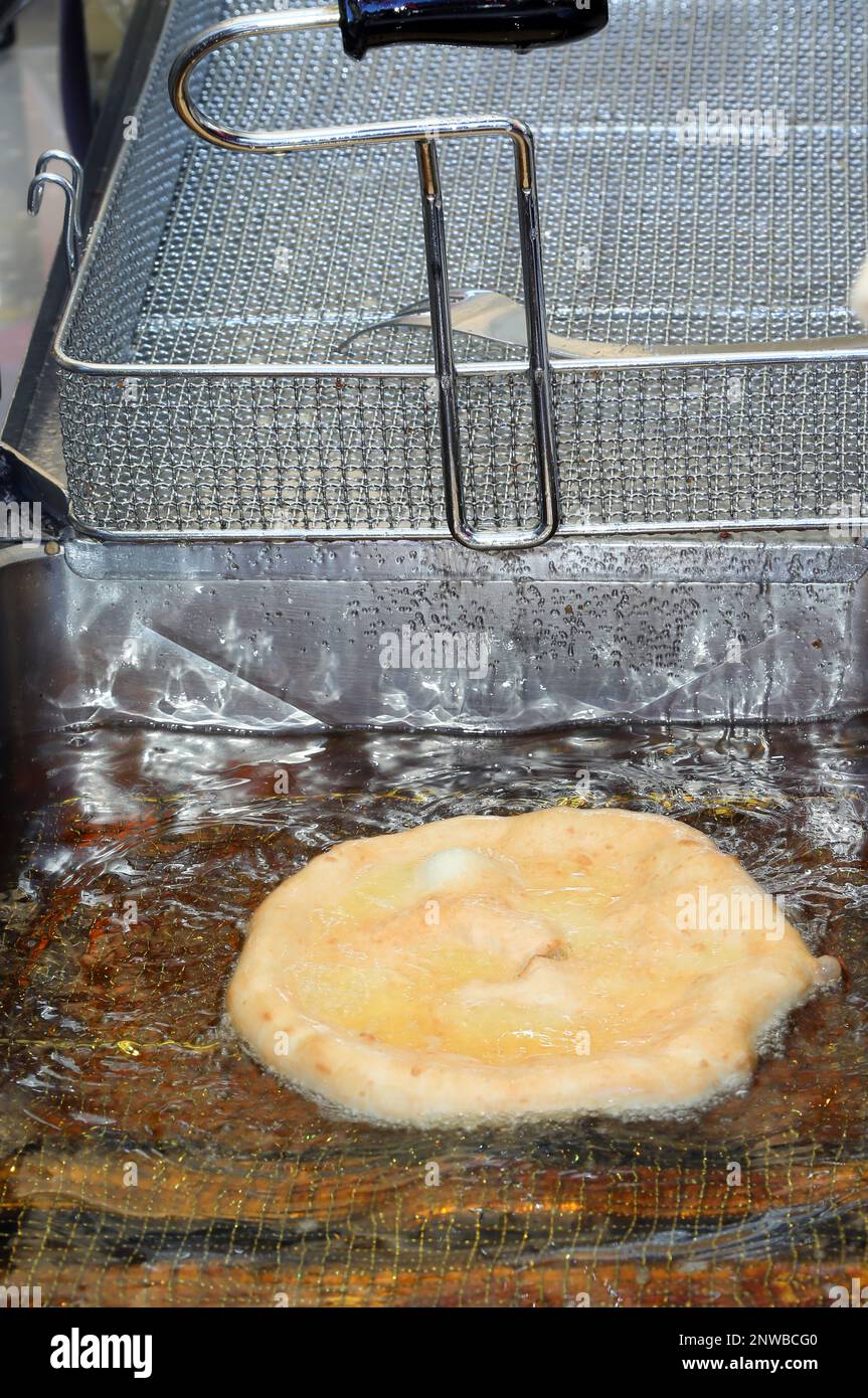 big fry them while frying in hot oil of industrial fryer Stock Photo ...