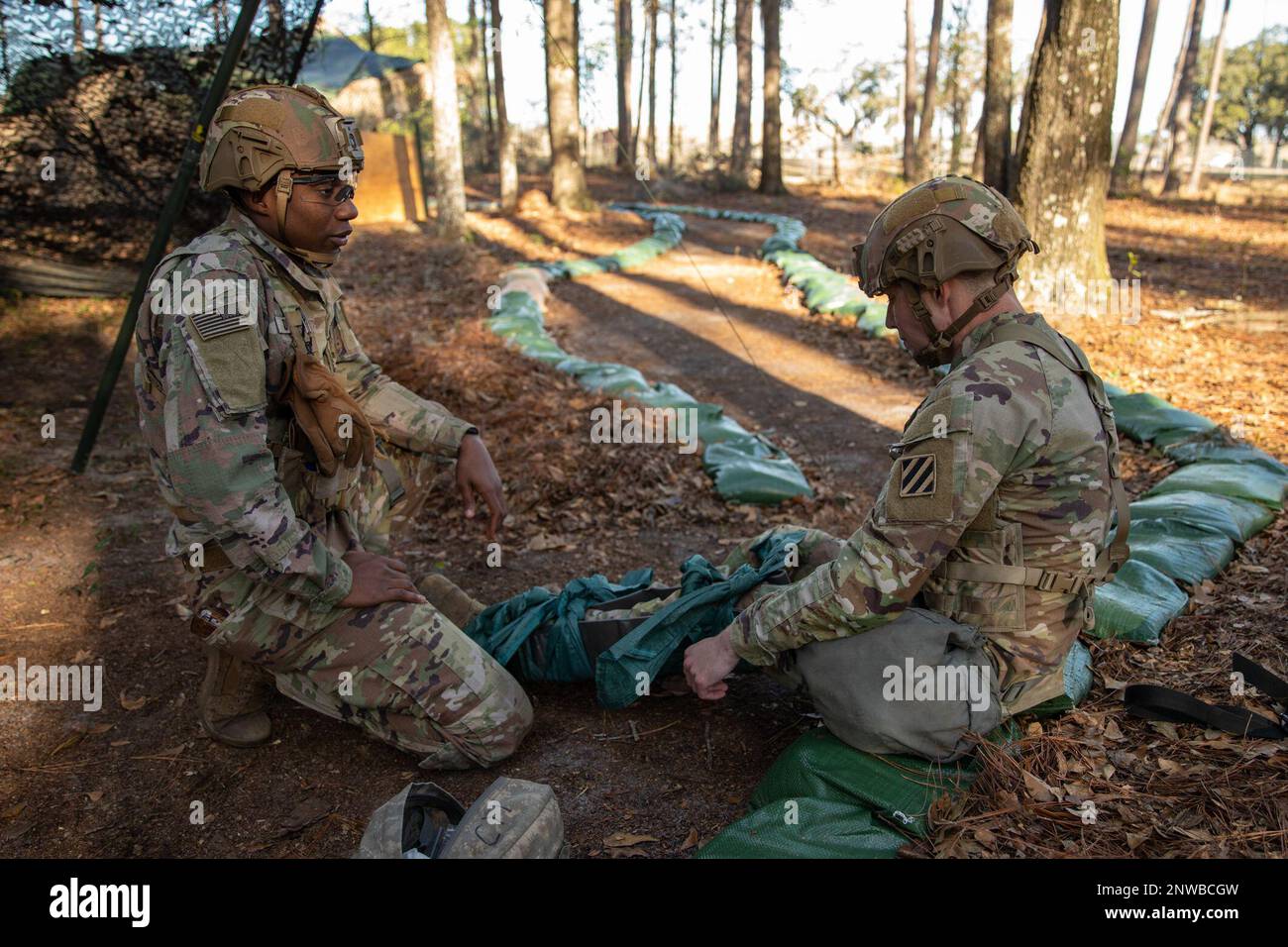Soldiers from the 3rd Infantry Division practice making and applying a ...