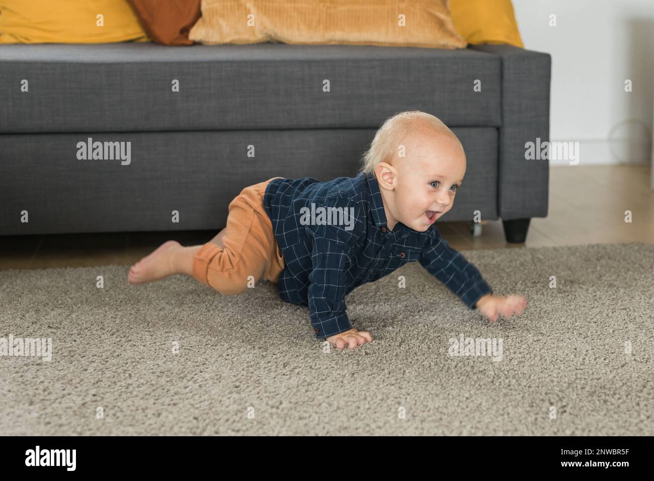 Nursery baby boy crawling on floor indoors at home - Baby curiosity and ...