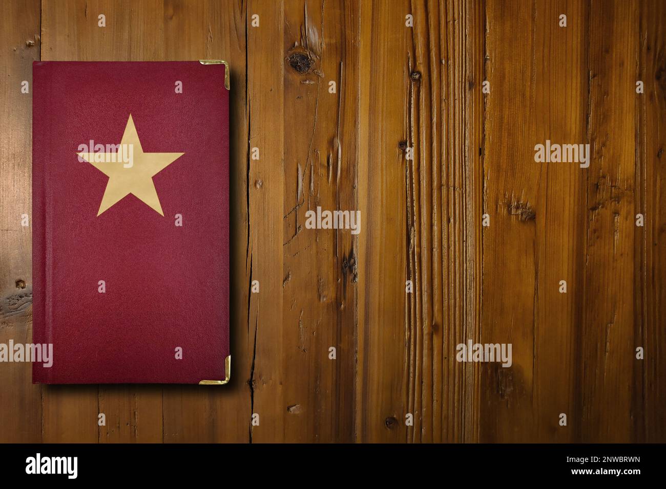 Close-up on a red book with a gilded star symbol in its middle Stock ...