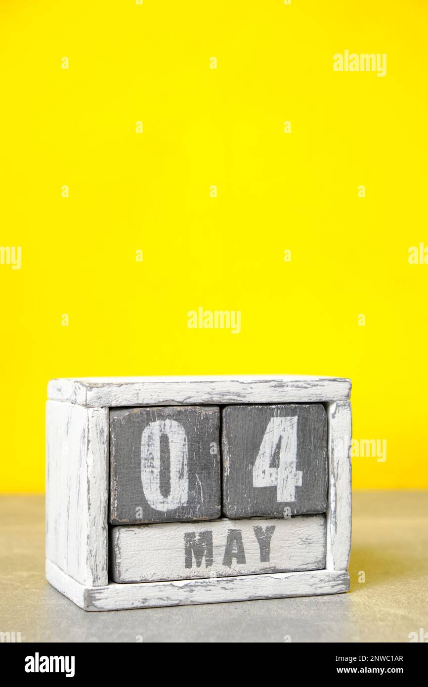 May 4, on calendar made wood painted in gray and white, yellow ...