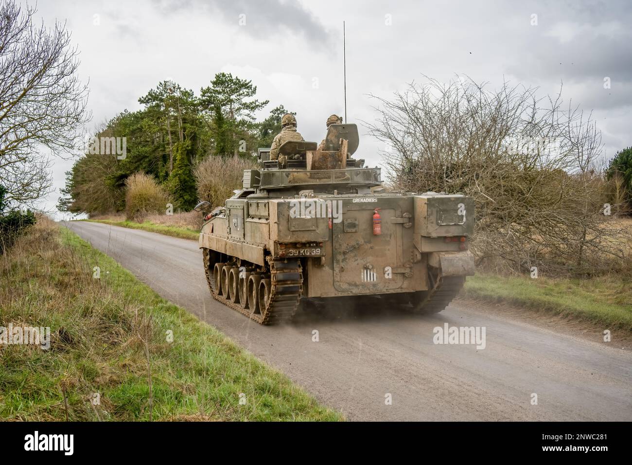 a British army Warrior FV510 fighting vehicle driving along a tarmac ...