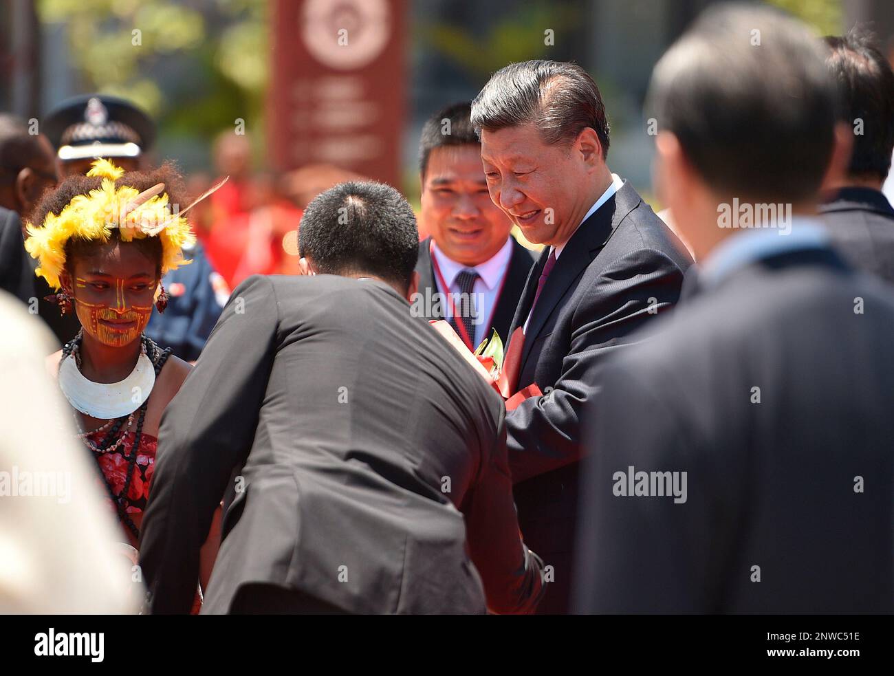 Chinese President Xi Jinping, center, receives flowers from pupils at ...