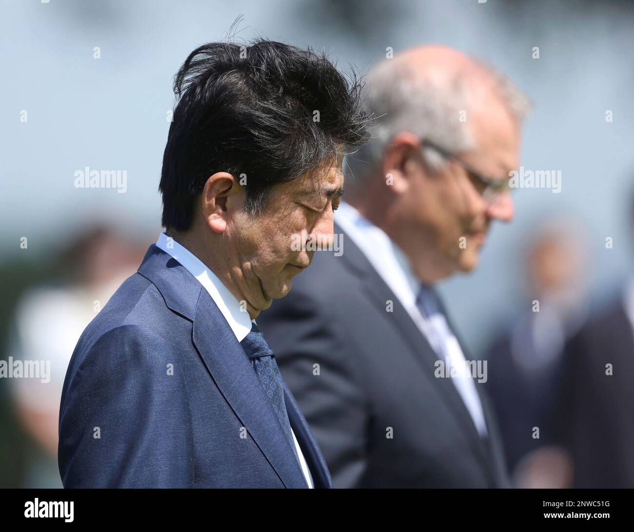 Japanese Prime Minister Shinzo Abe, observes a silent prayer after ...