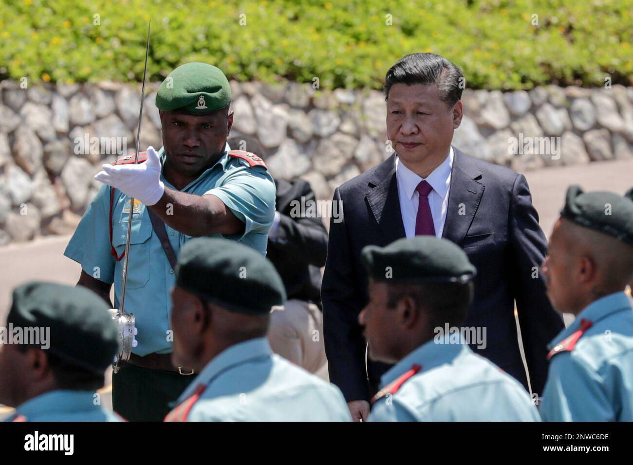 Chinese President Xi Jinping, right, is seen behind a row of honor ...