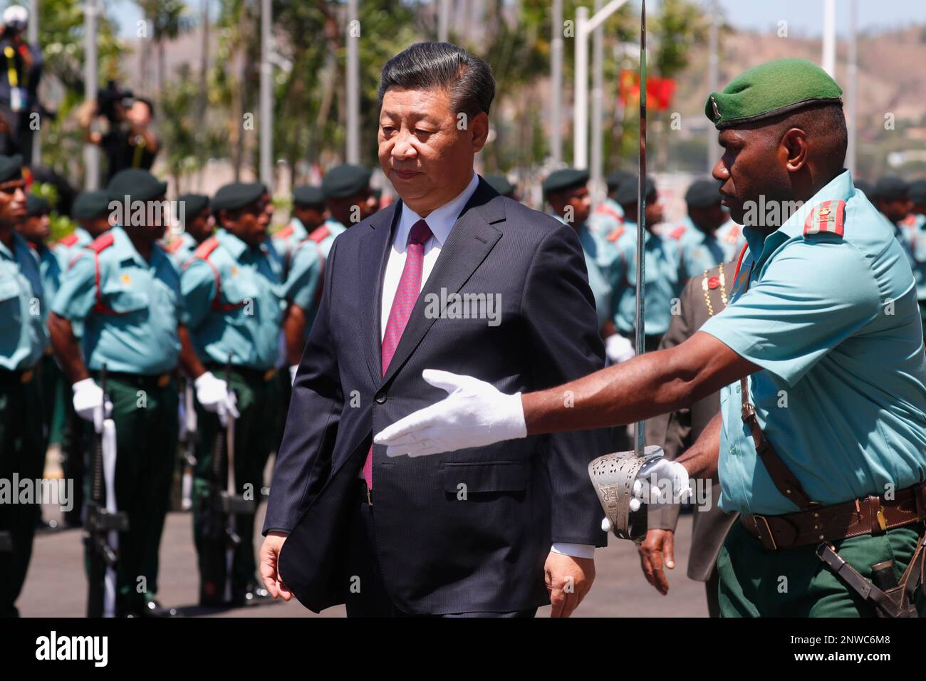 China's President Xi Jinping is shown the way during a welcome ceremony ...
