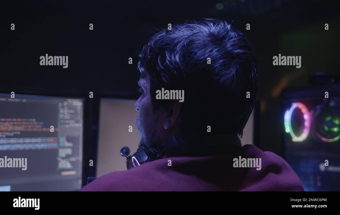 Game Developer Or Programmer Developing Code On Computer At Desk Stock