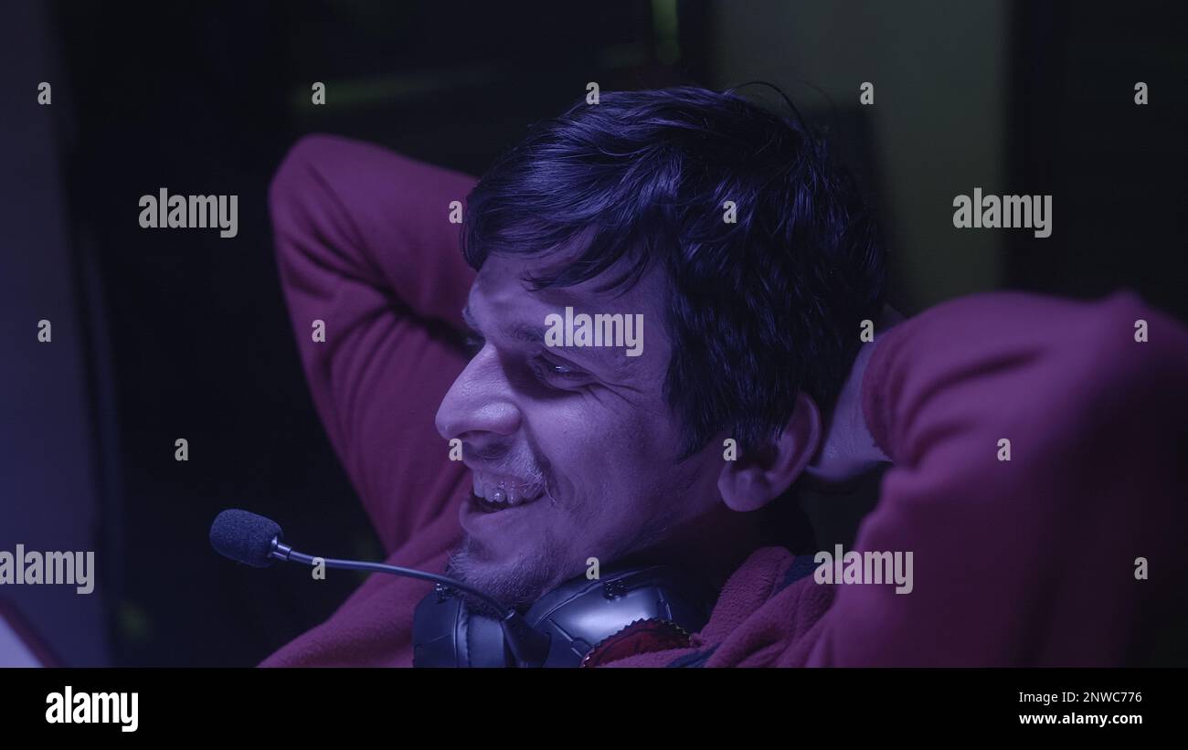 Gamer Enjoying Video Game at Computer with Colorful Lights and Throws ...