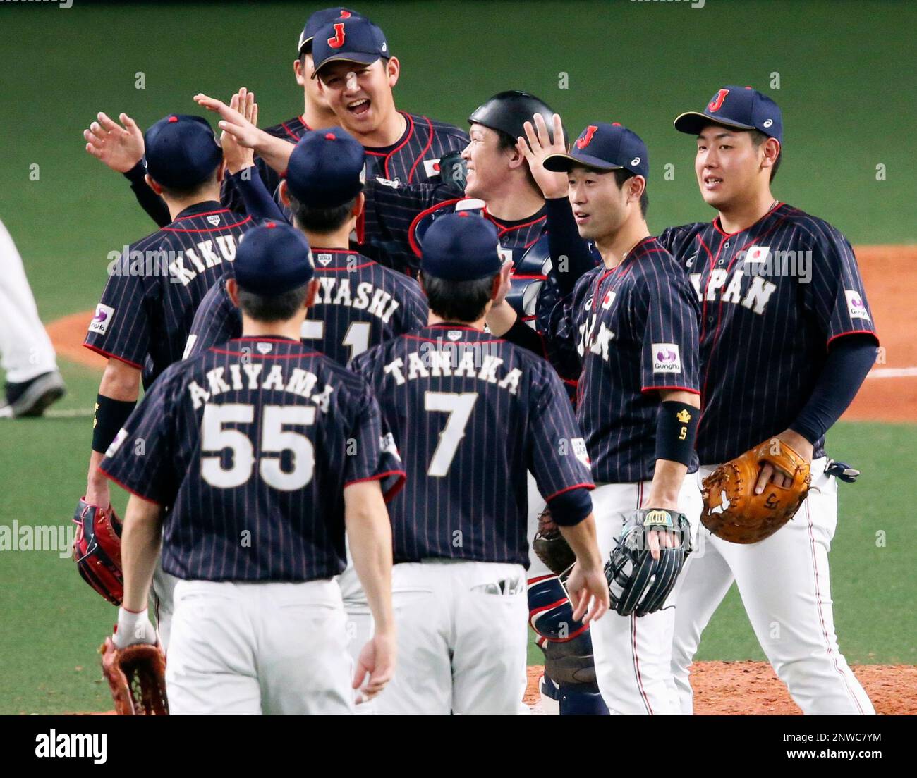 All Japan closer Yasuaki Yamasaki, back facing camera, celebrates with ...