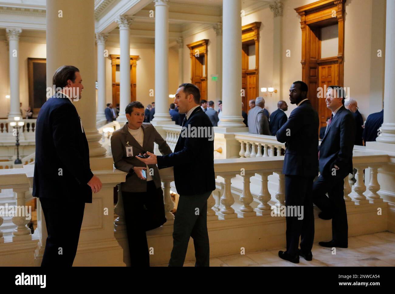 Lobbyists stand in the halls outside the house chamber. The special ...