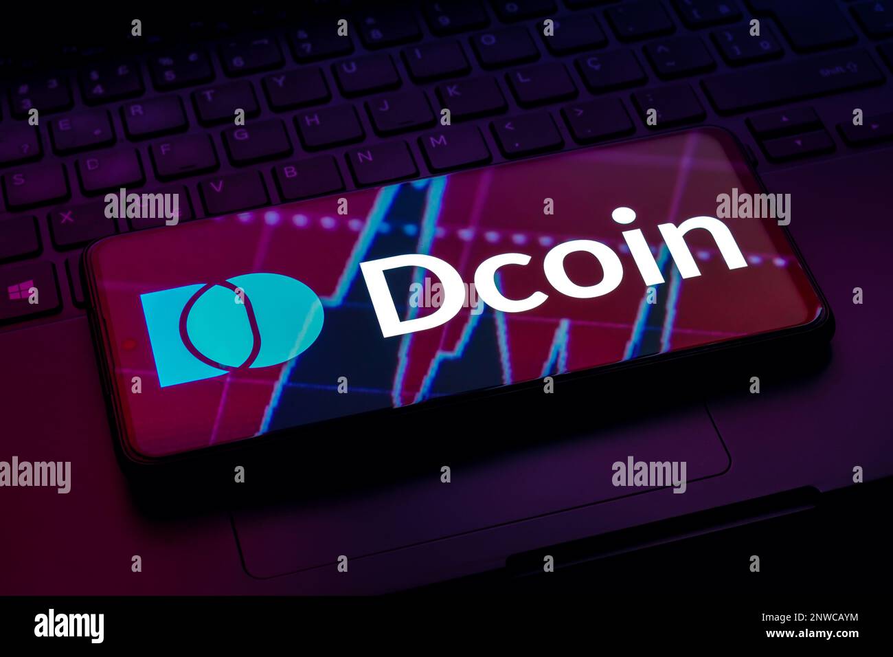 In this photo illustration, the Dcoin logo seen displayed on a ...