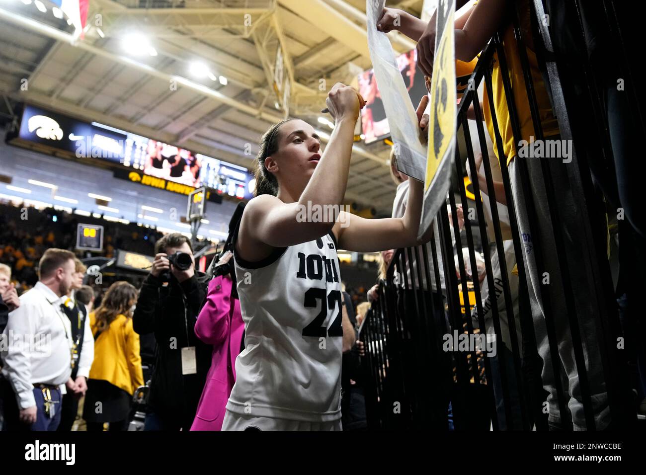 Iowa guard Caitlin Clark signs autographs for fans as she walks off the ...