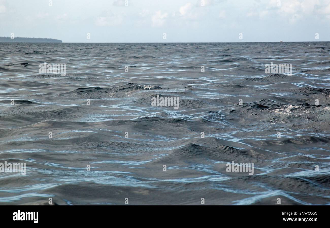 Close up shot of moderately rough sea water shot from a boat for use as ...