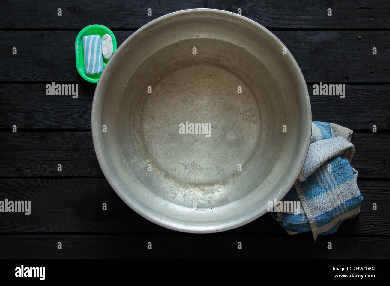 an aluminum bowl with soapy water after washing your feet is on the ...