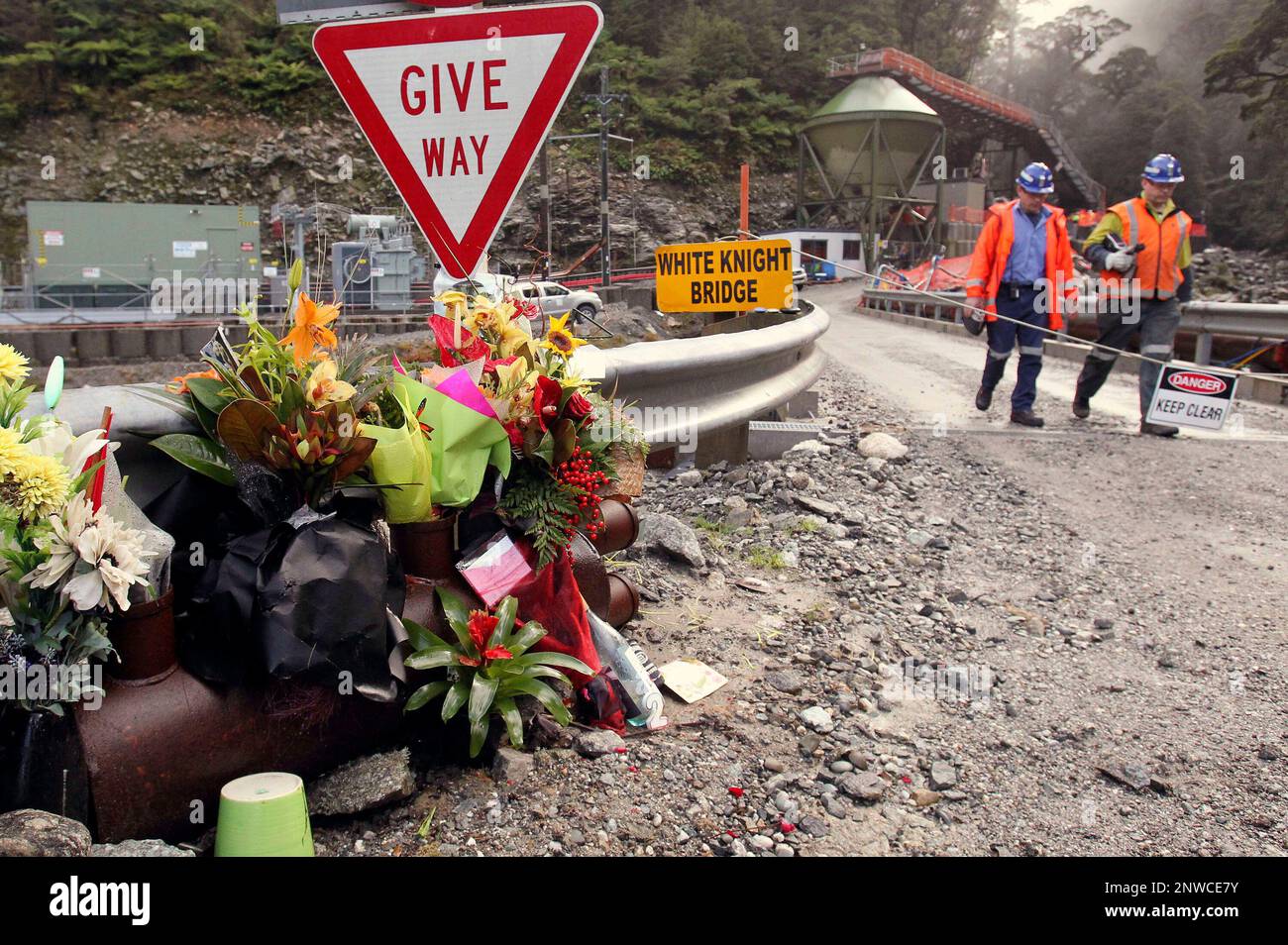 FILE - In this June 28, 2011 file photo, workers walks past a bouquet ...