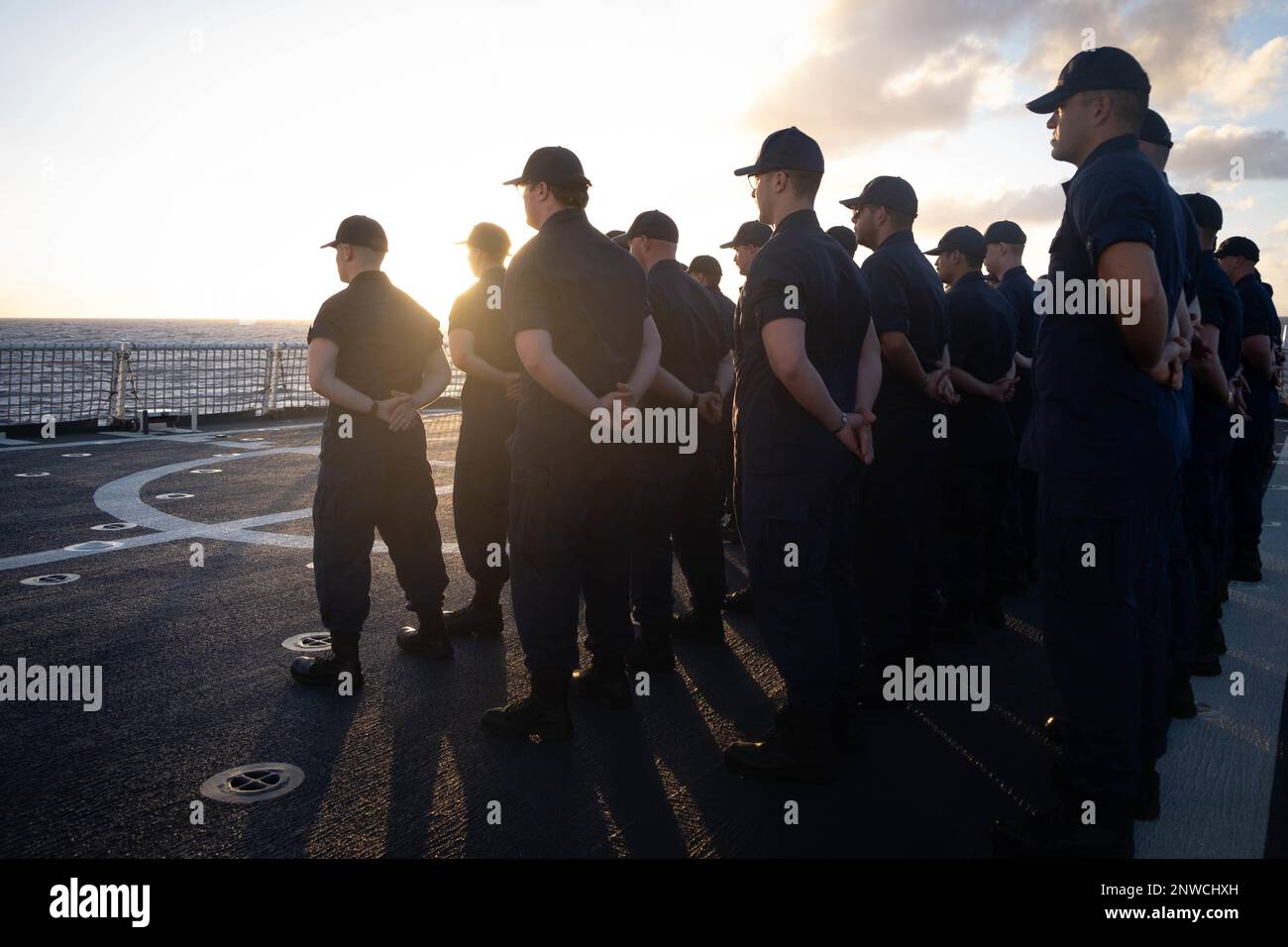 Crew members assigned to USCGC Stone (WMSL 758) stand at parade rest ...